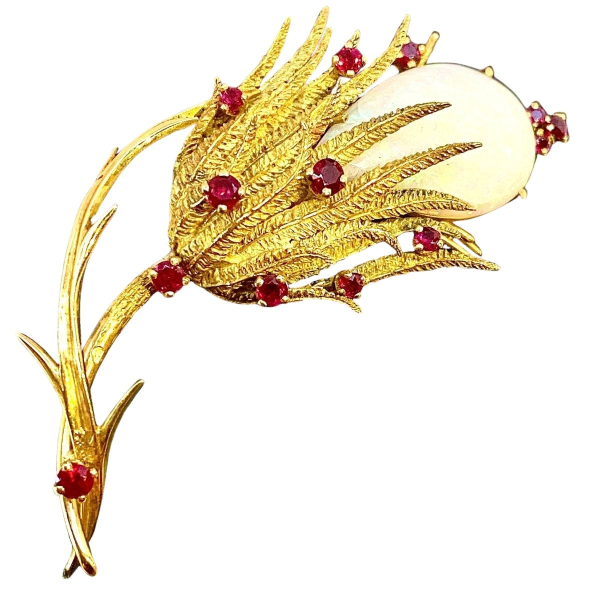 18-karat gold brooch decorated with a large opal and 13 rubies, circa ...